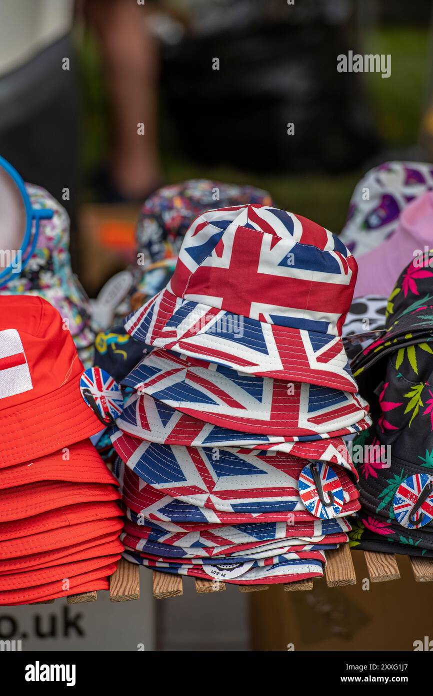 Pile of Union flag or union jack design hats on sale on a market stall ...
