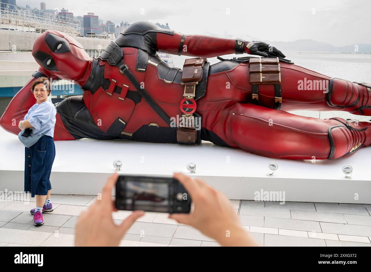 A visitor has her photo taken as she poses with the 8-meter ...