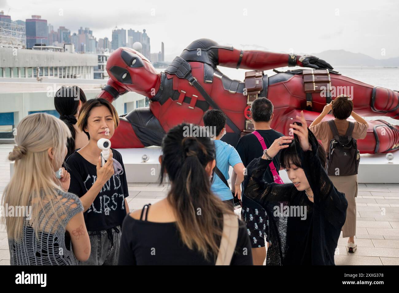 Locals and tourists pose for photos with the 8-meter installation of ...