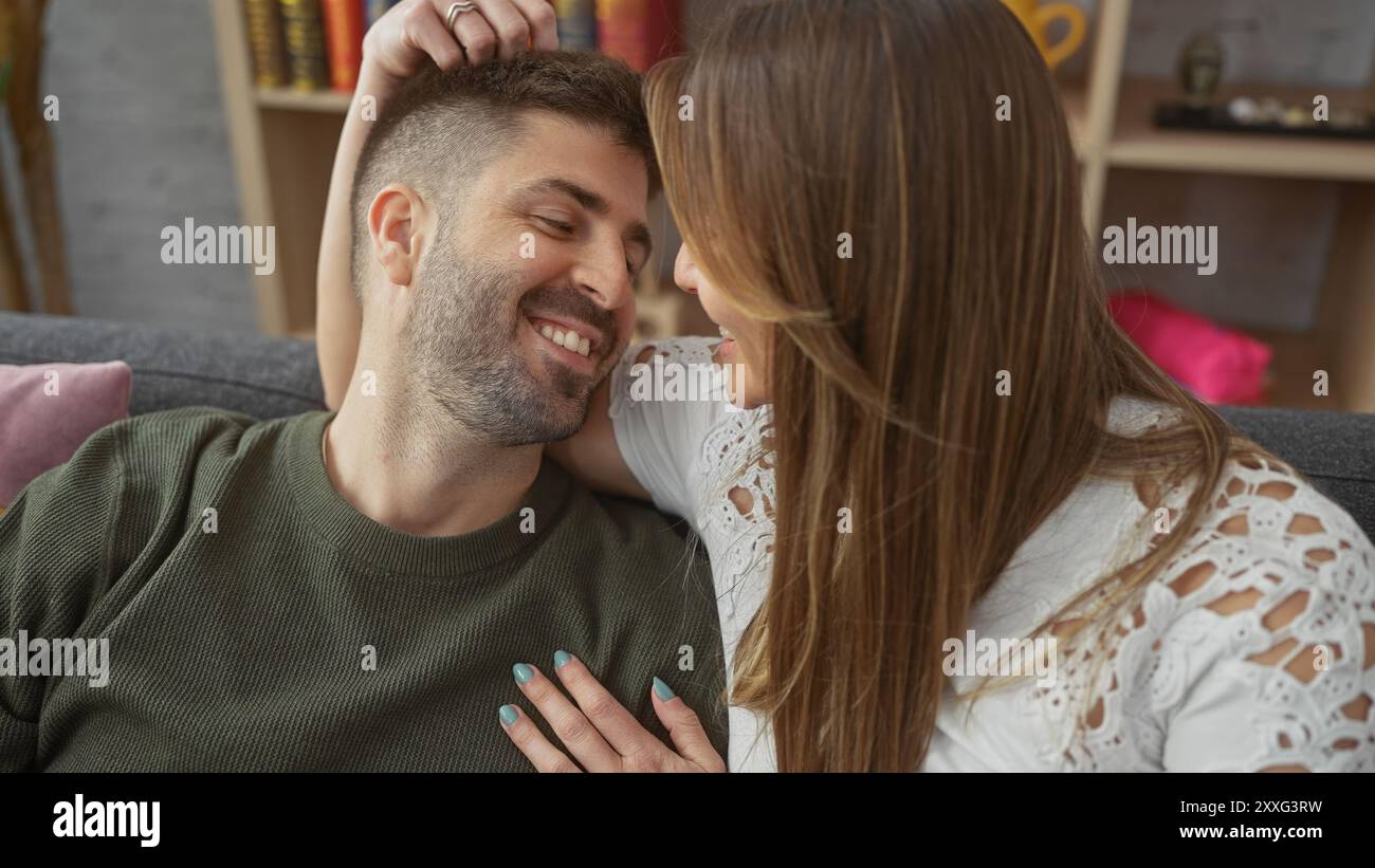 A loving couple enjoys a cozy moment together, cuddling in a modern ...