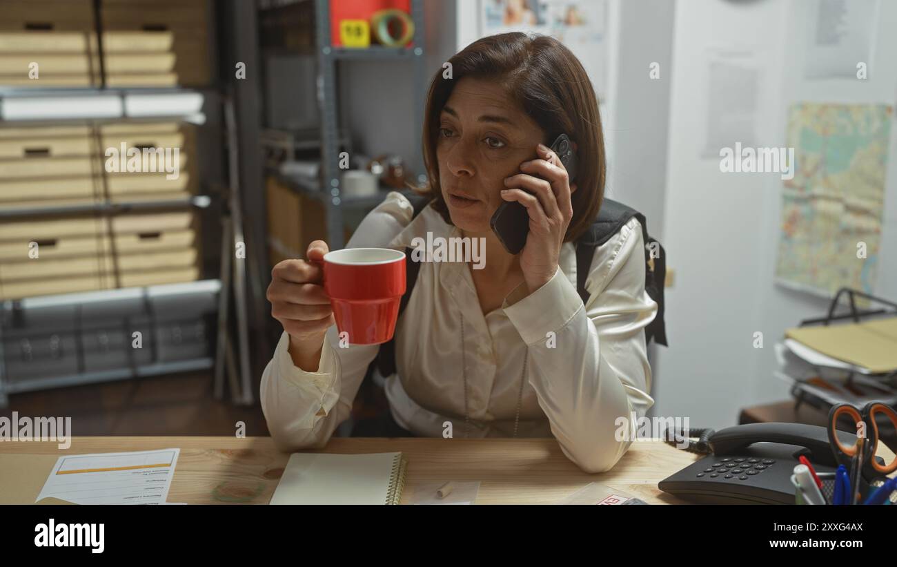 Hispanic woman detective with phone and coffee in an office, surrounded ...