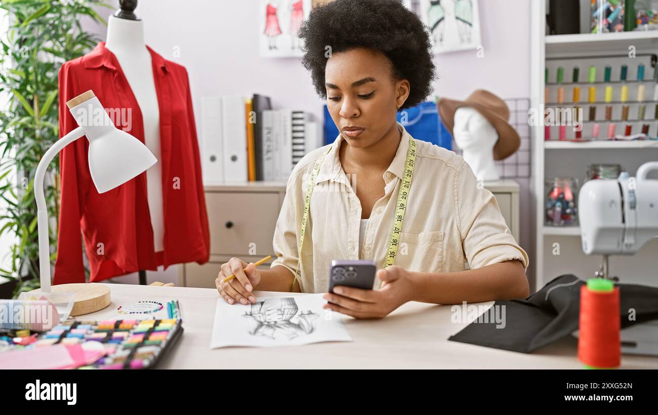 African american woman dressmaker using smartphone in tailor shop with ...