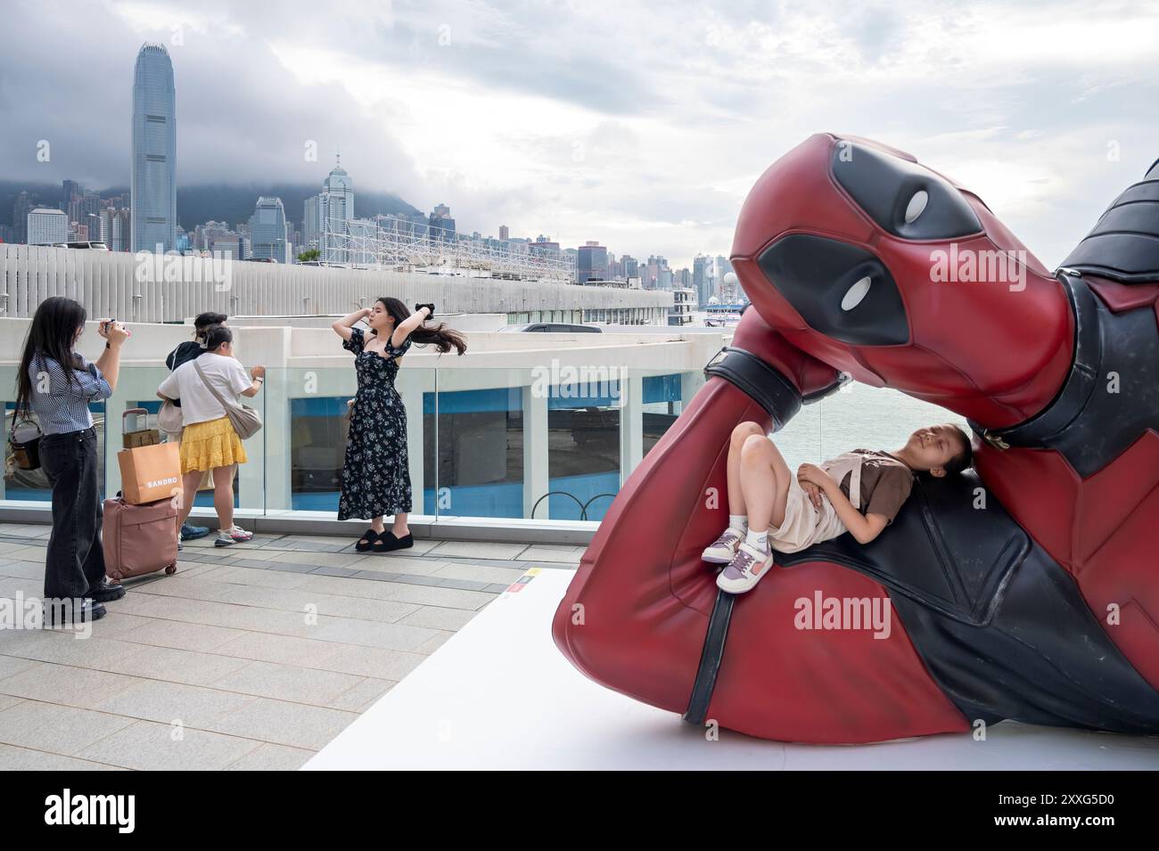 Hong Kong, China. 18th Aug, 2024. A child poses for a photo with the 8 ...