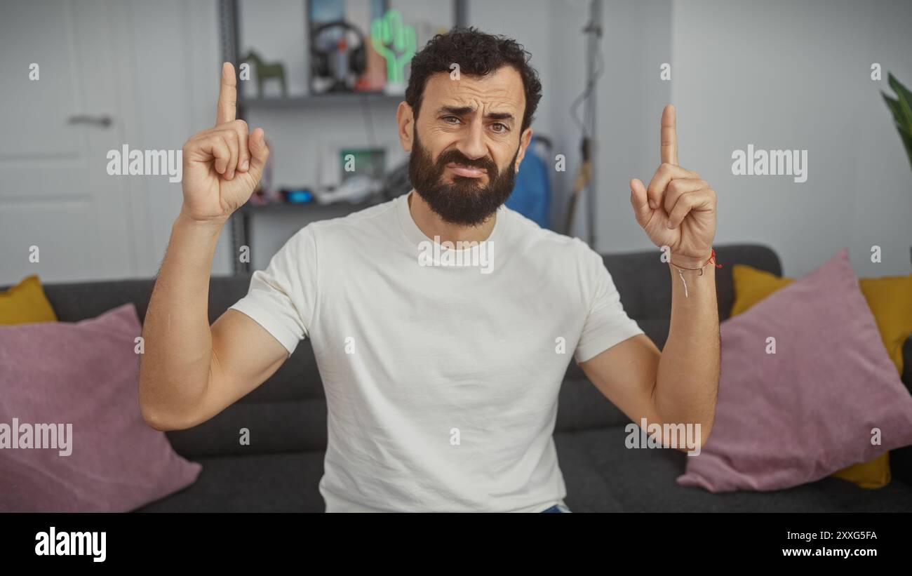 Middle-aged bearded man in white shirt looking puzzled with raised ...
