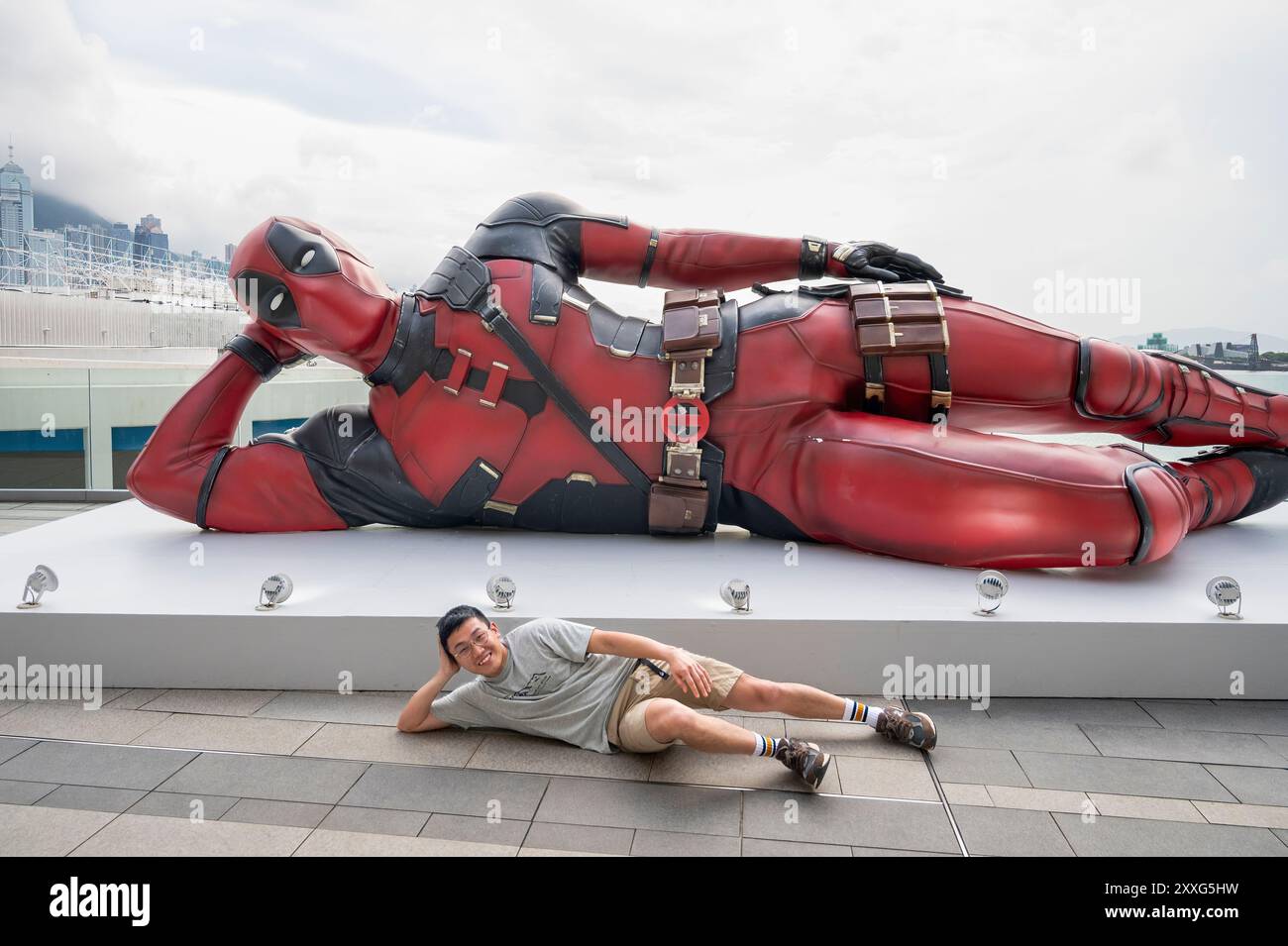 Hong Kong, China. 18th Aug, 2024. A visitor has his photo taken as he ...