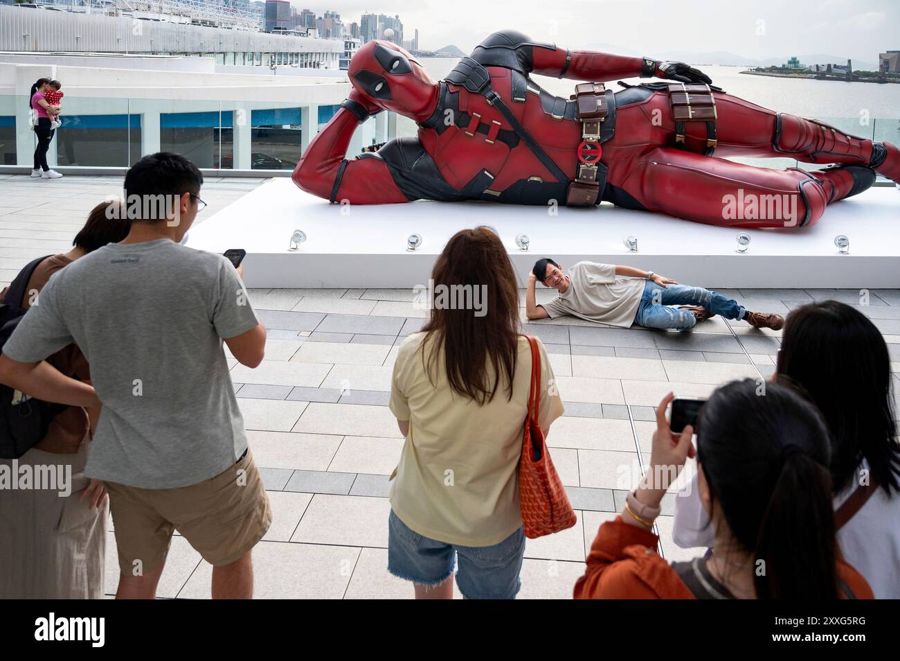 Hong Kong, China. 18th Aug, 2024. A visitor has his photo taken as he ...
