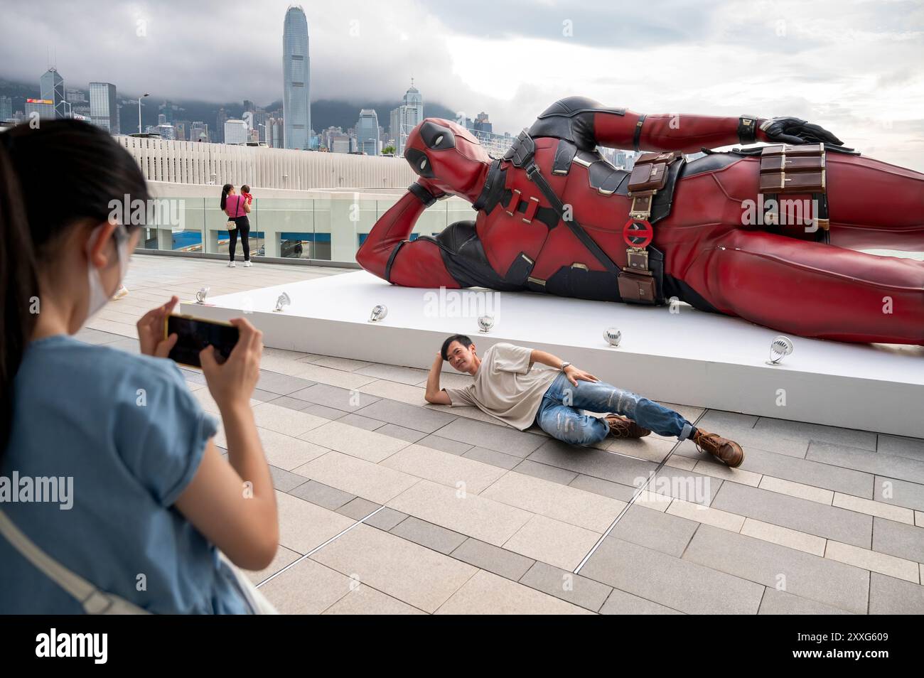 Hong Kong, China. 18th Aug, 2024. A visitor has his photo taken as he ...