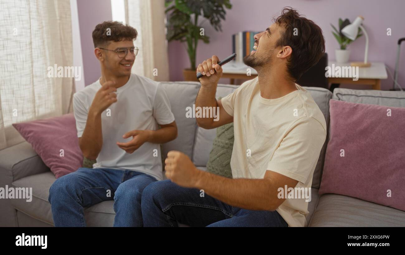 Father and son singing using the tv remote as a microphone while ...