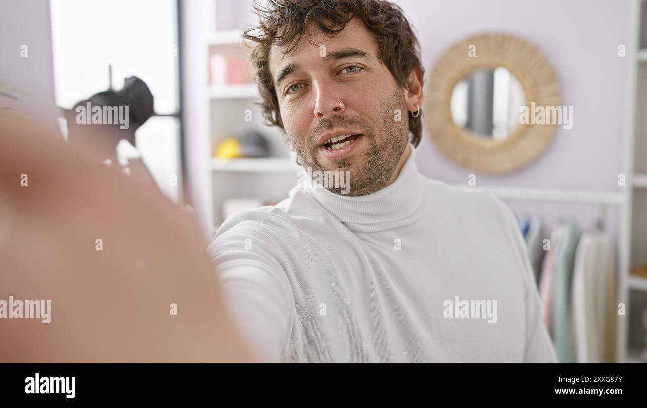 Handsome hispanic man takes a selfie in a well-organized dressing room ...