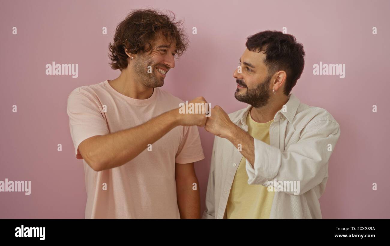 Men laughing together in friendly gesture, showing a fist bump against ...