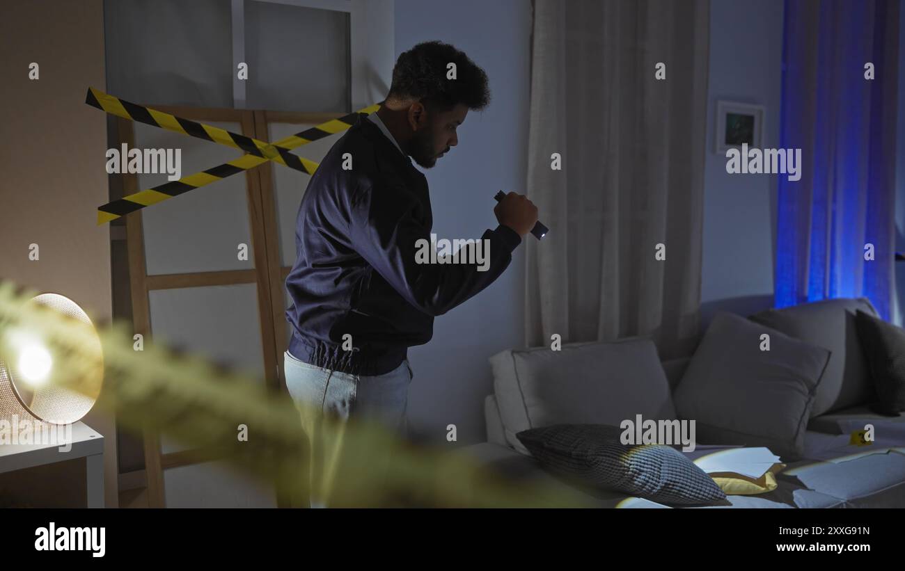 African man investigating a dimly lit indoor crime scene with warning ...