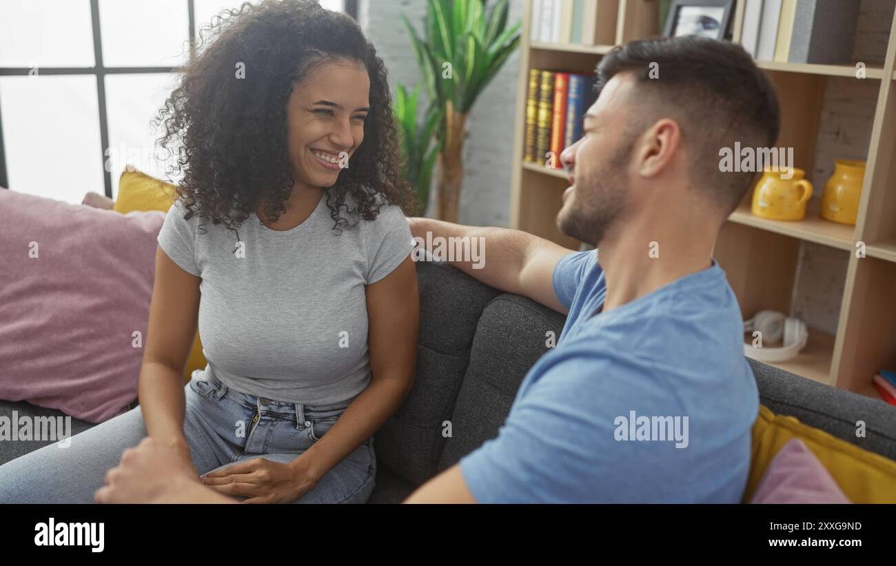 A loving couple enjoys a relaxed interaction on a comfortable couch in ...