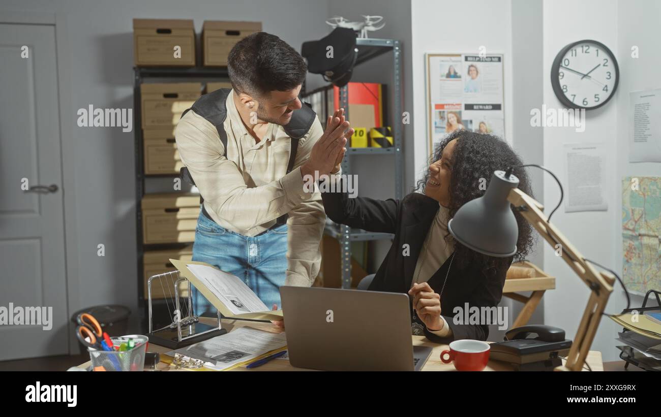 Two detectives, a man and a woman, celebrate success in a cluttered ...