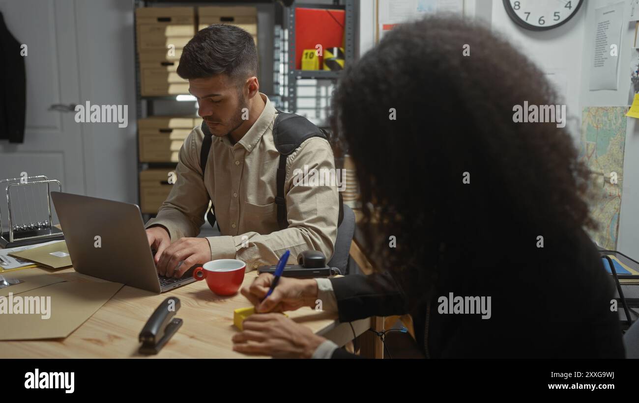 Man and woman investigators working together at a police station with ...