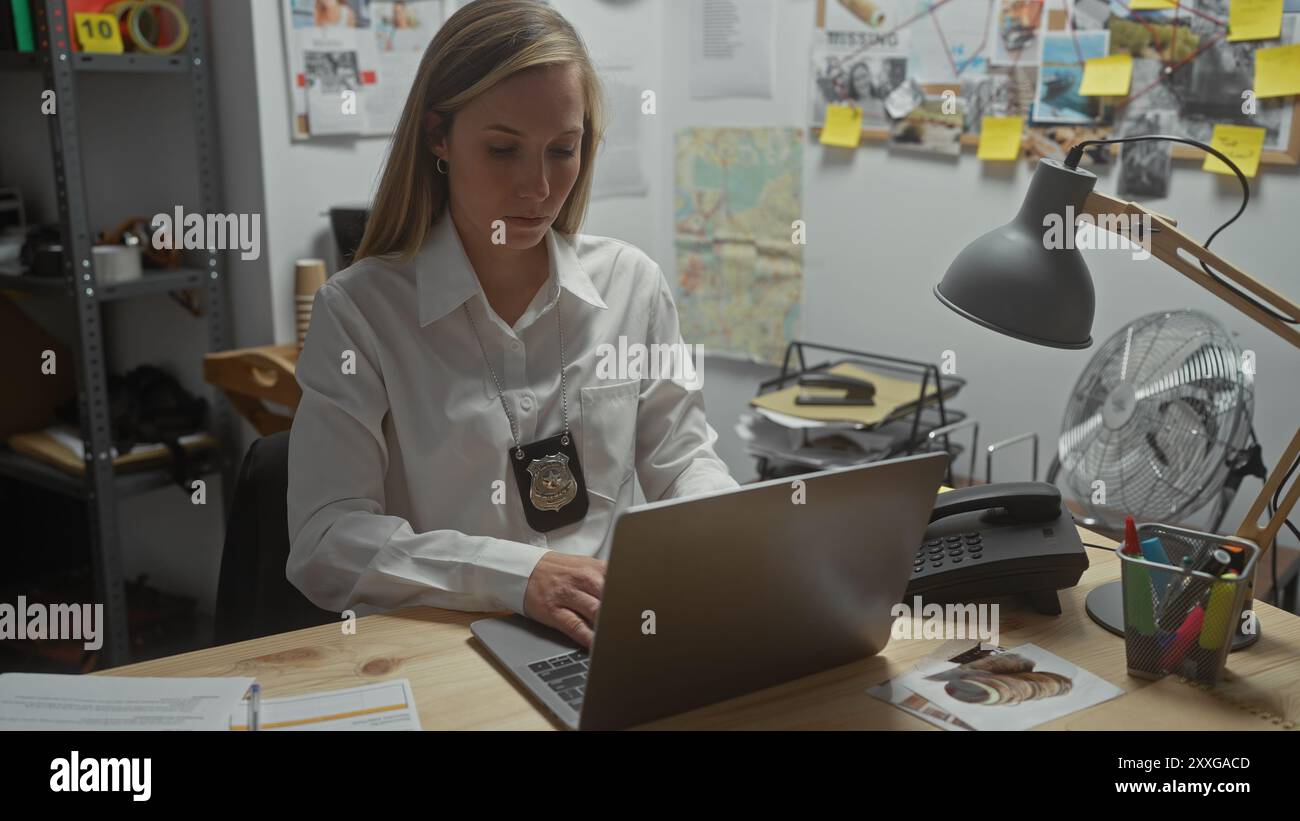 Caucasian woman detective working on laptop in police station office ...