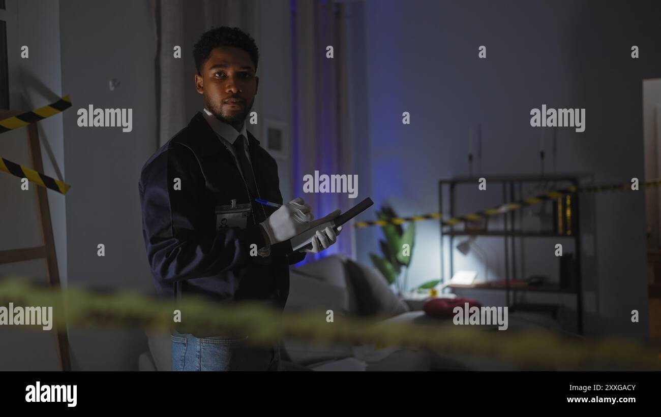 African american detective taking notes at a crime scene indoors with ...