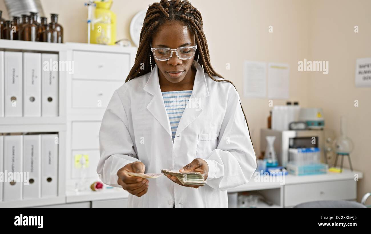 African american woman scientist with braids counting money in an ...