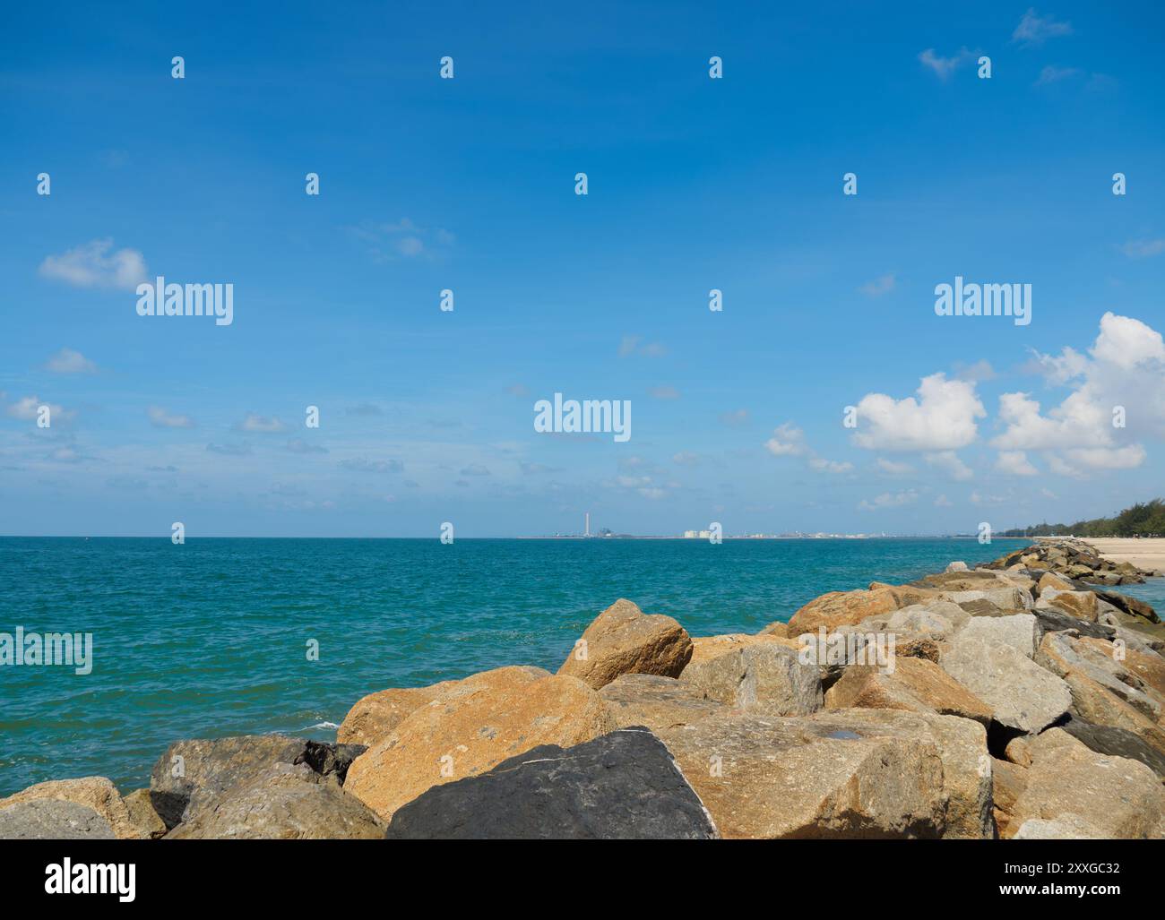 Tropical emerald sea, open air and space with rock breakwater on the ...