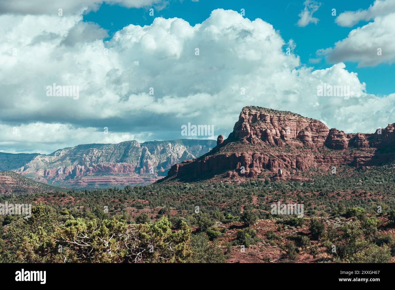 The Red Rocks of Sedona, Arizona sit beneath towering white clouds in a ...