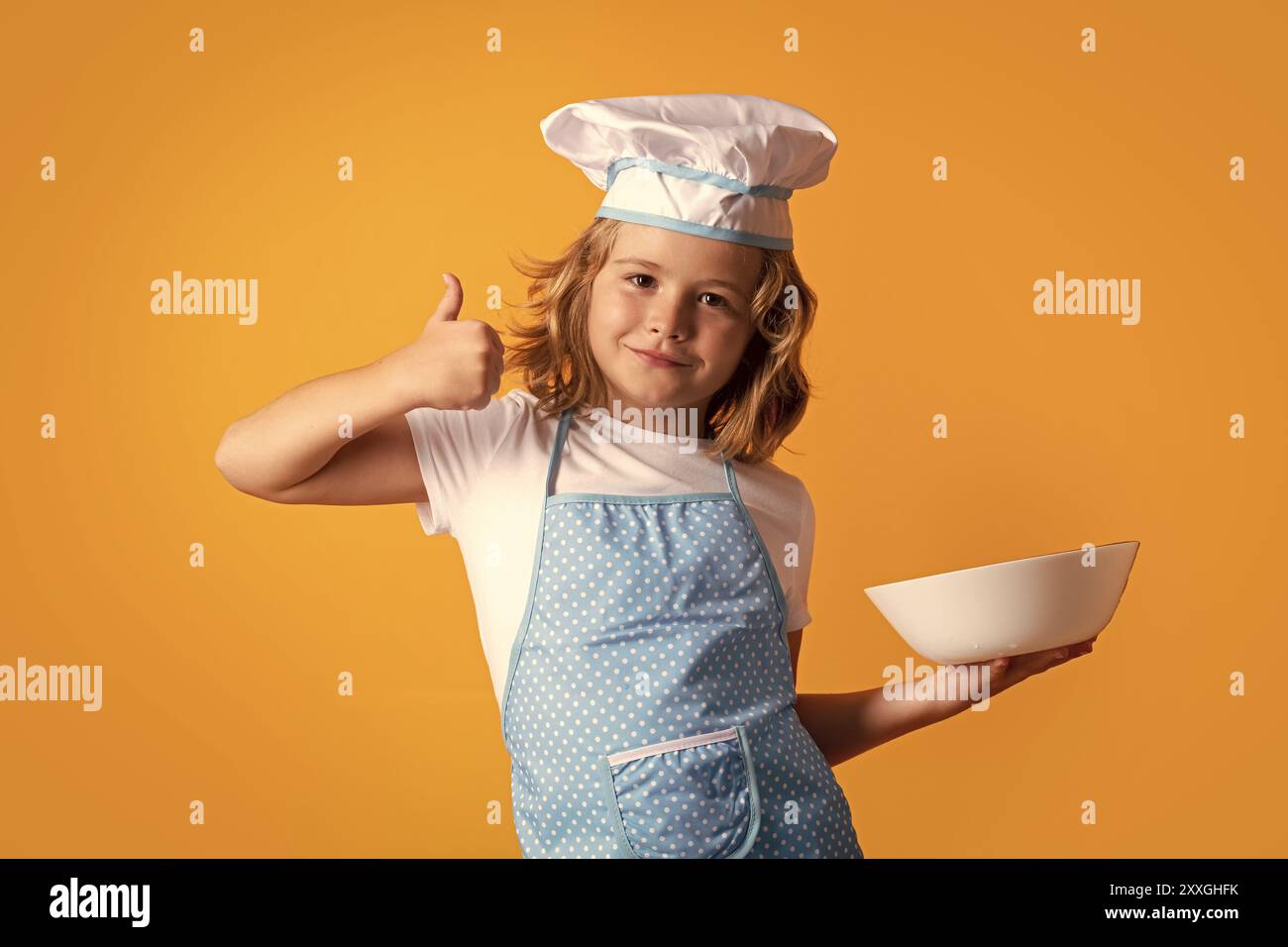 Funny kid chef cook with kitchen plate, studio portrait. Child chef ...