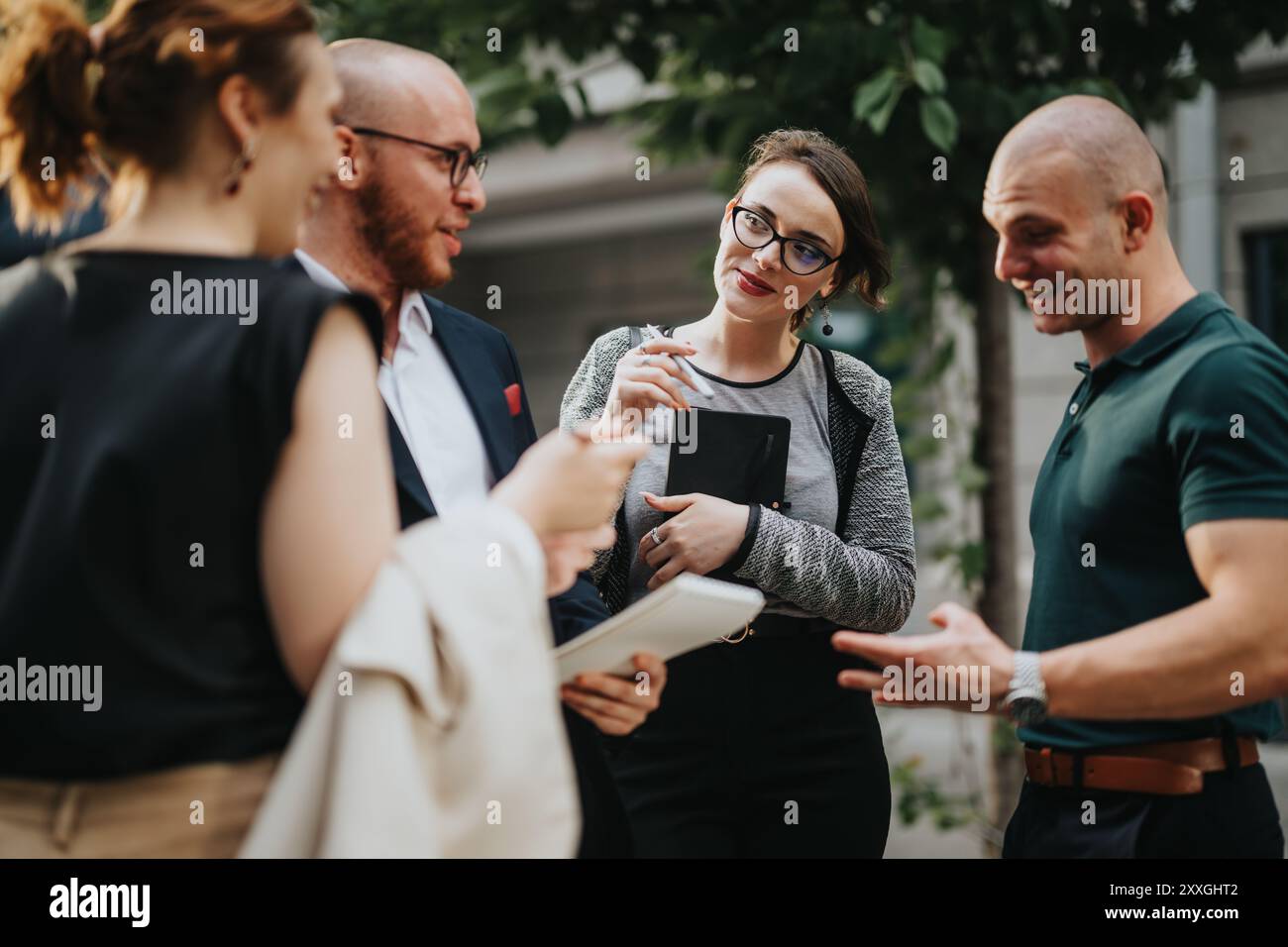 Group of professionals having an outdoor business meeting and ...