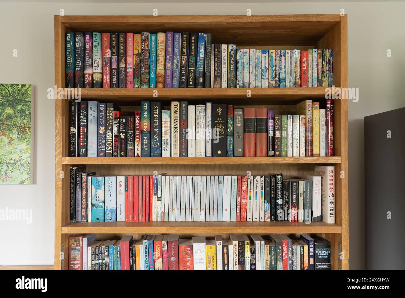 Bookcase in an English home with a selection of popular and literature ...