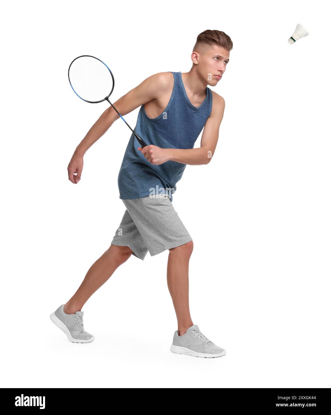 Young man playing badminton with racket and feather shuttlecock on ...