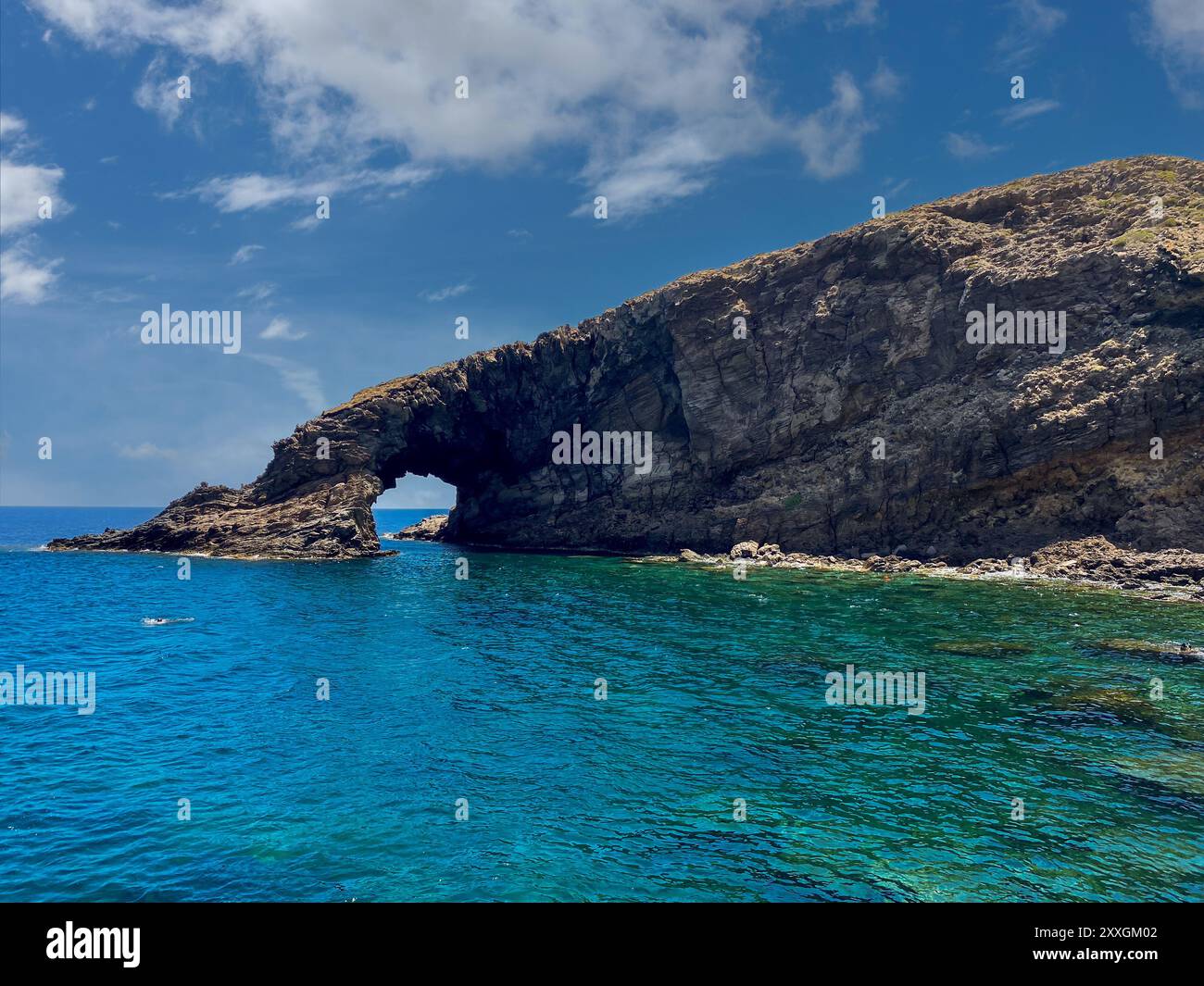 Elephant Arch huge lava rock cliff plunging into the water forming an ...