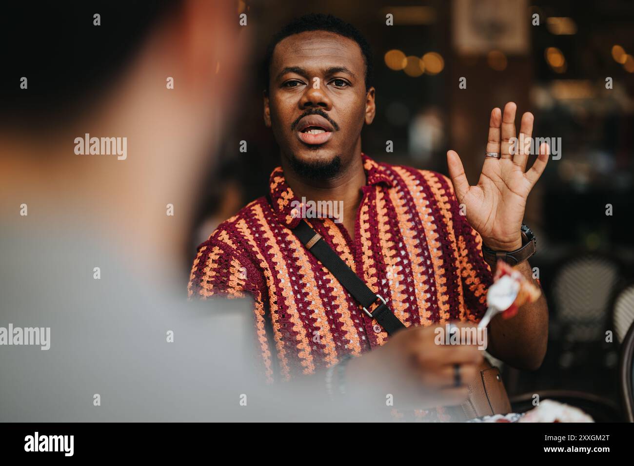 Businessperson expressing ideas during a casual discussion at a coffee ...