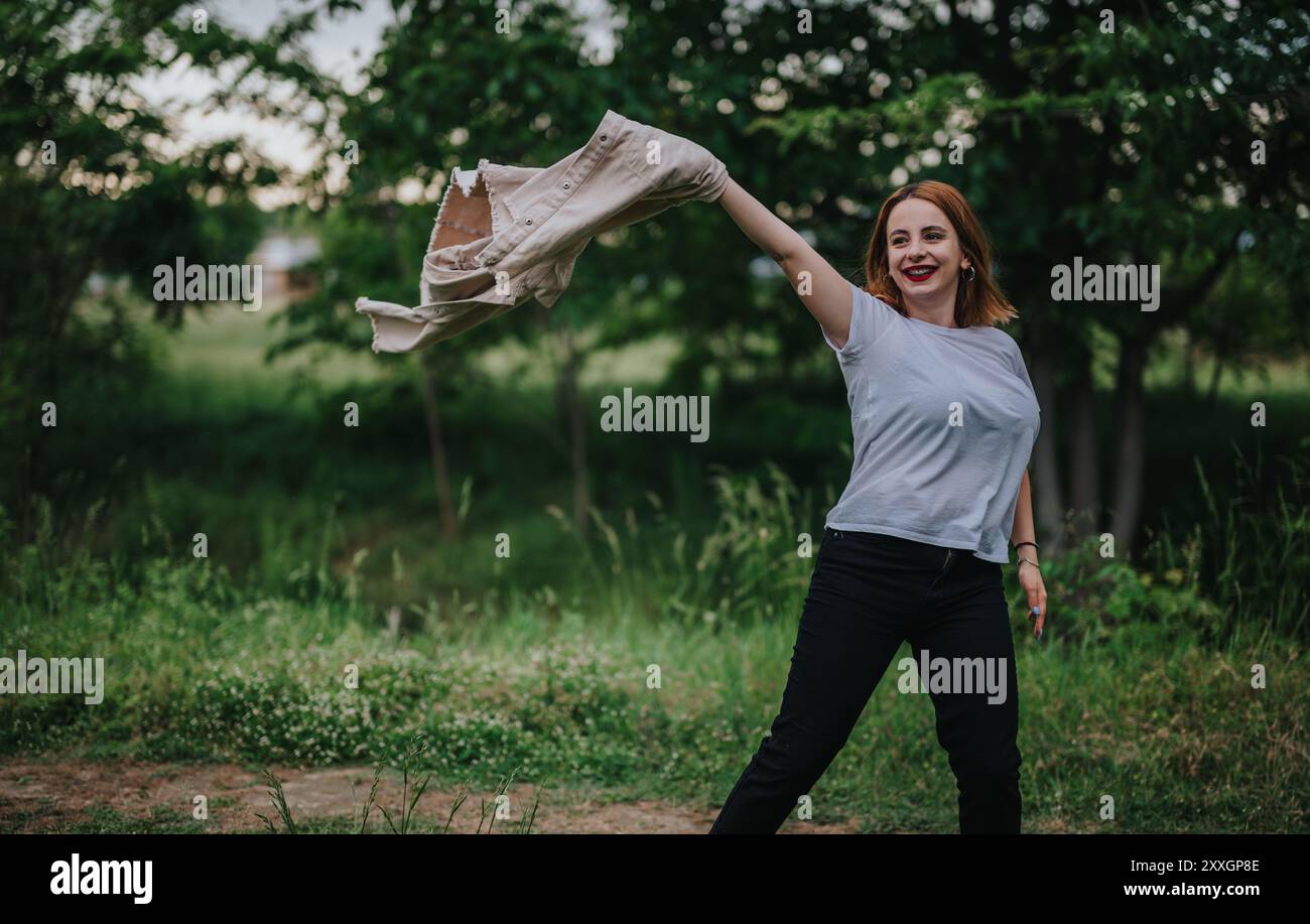 Woman joyfully throwing jacket hi-res stock photography and images - Alamy