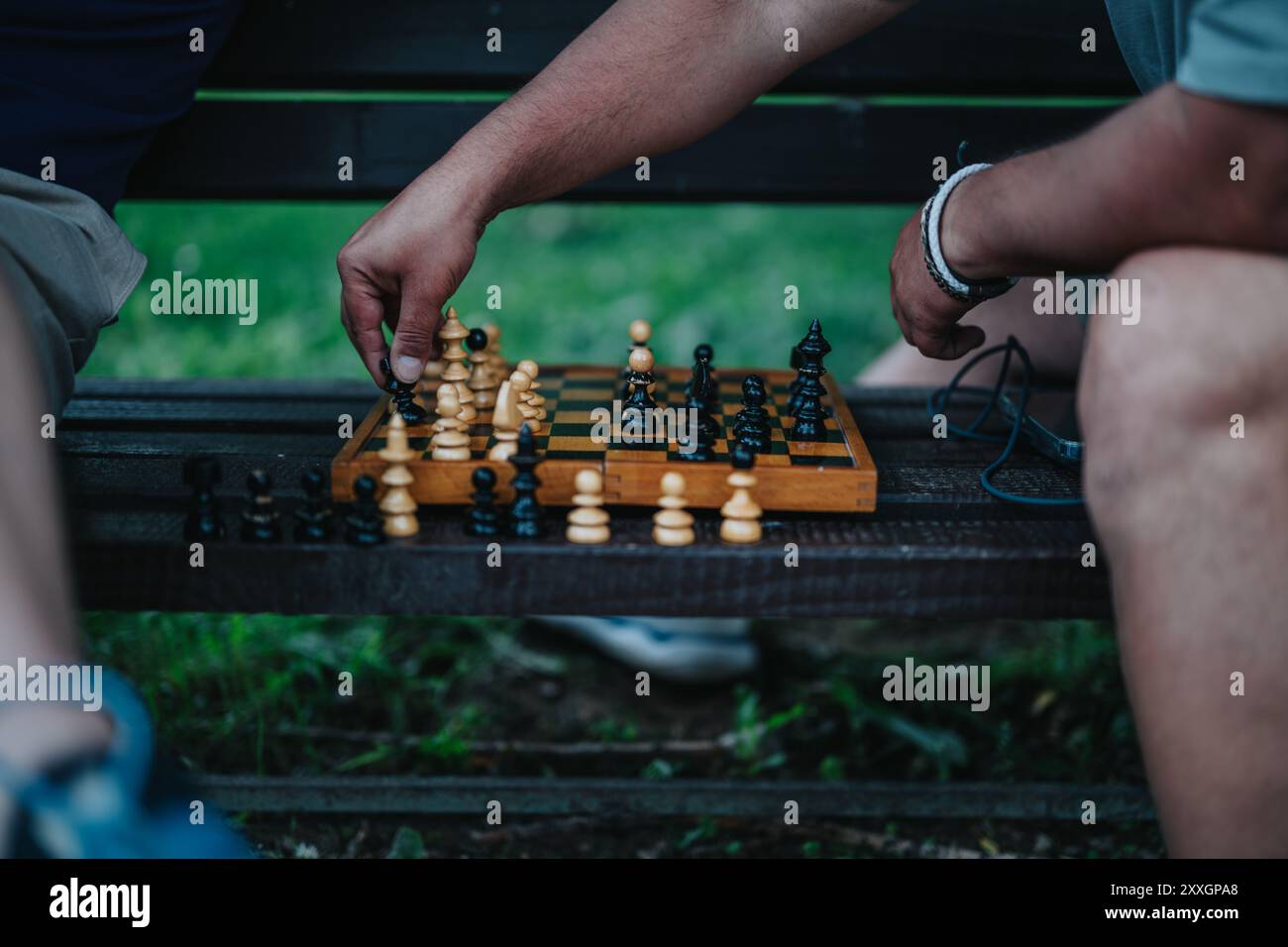 Two people enjoying a strategic game of chess outdoors Stock Photo - Alamy