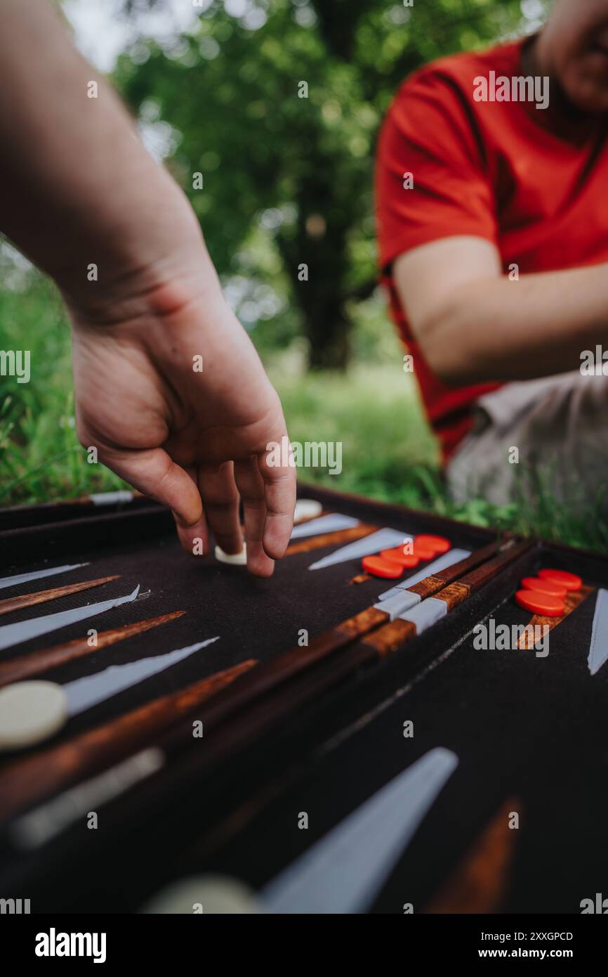 Outdoor backgammon game with friends in a park setting Stock Photo - Alamy