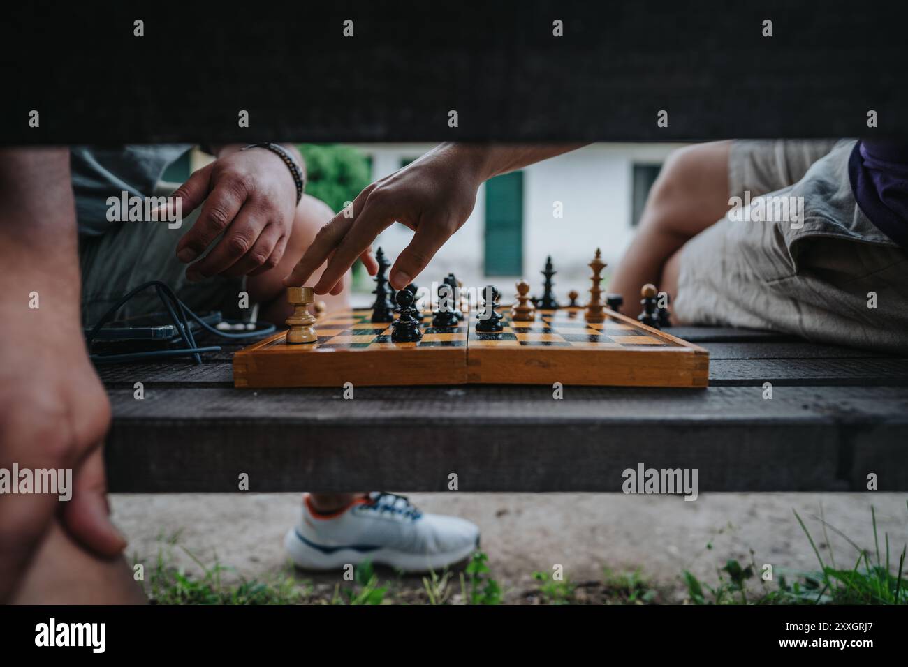 Two people playing chess outdoors during a casual game session Stock ...
