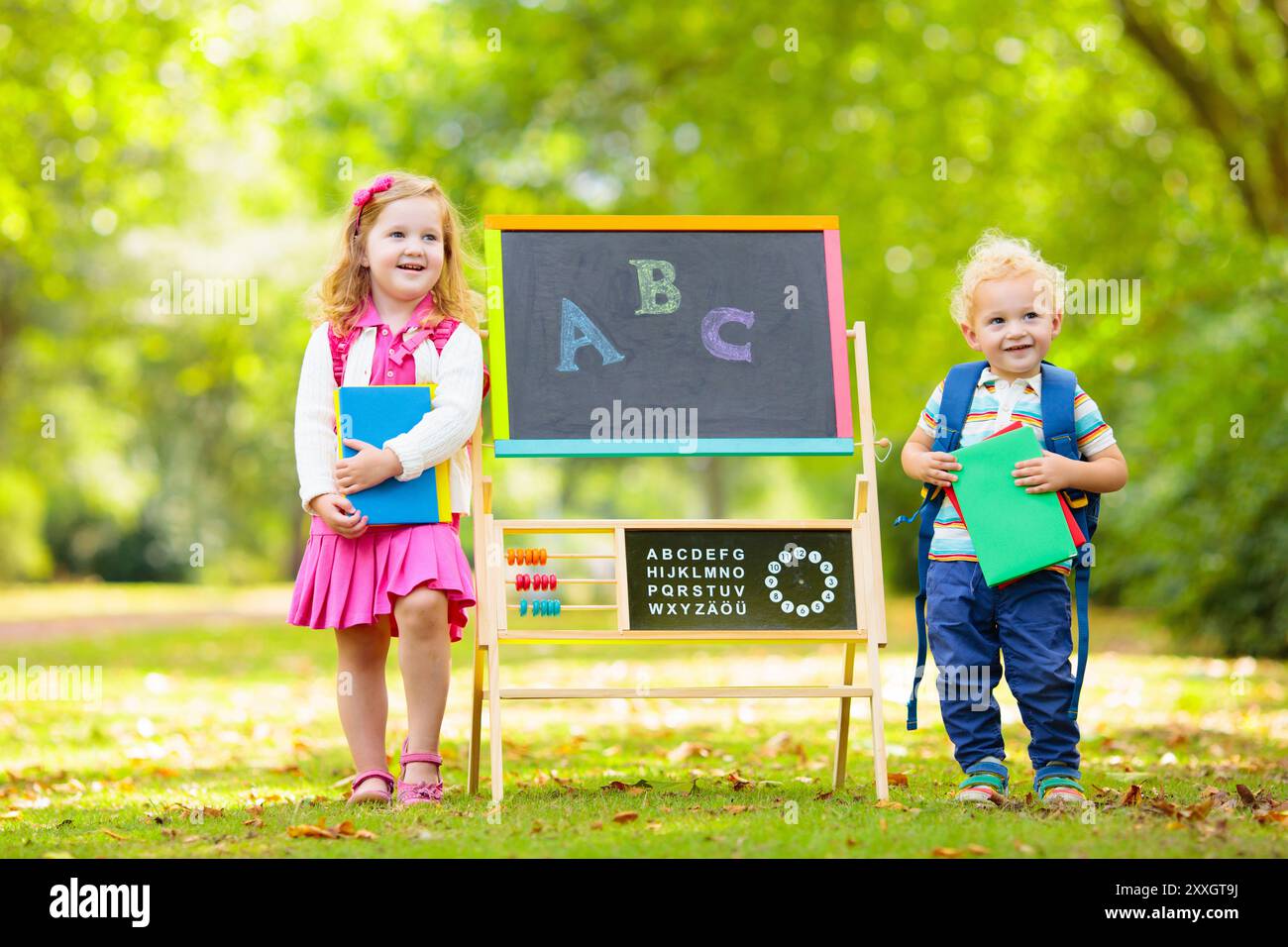 Children happy to be back to school. Preschooler girl and boy with ...