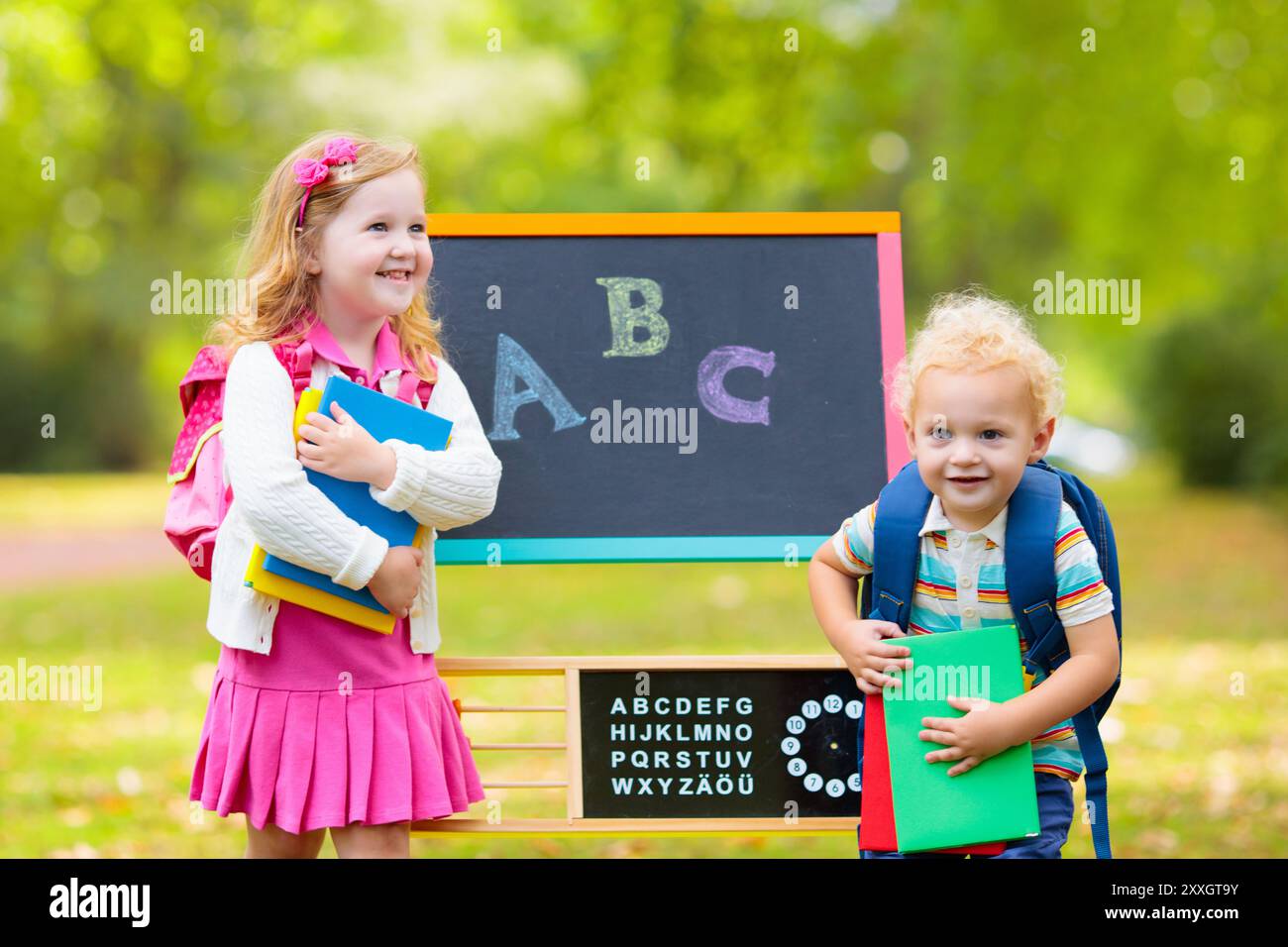 Children happy to be back to school. Preschooler girl and boy with ...