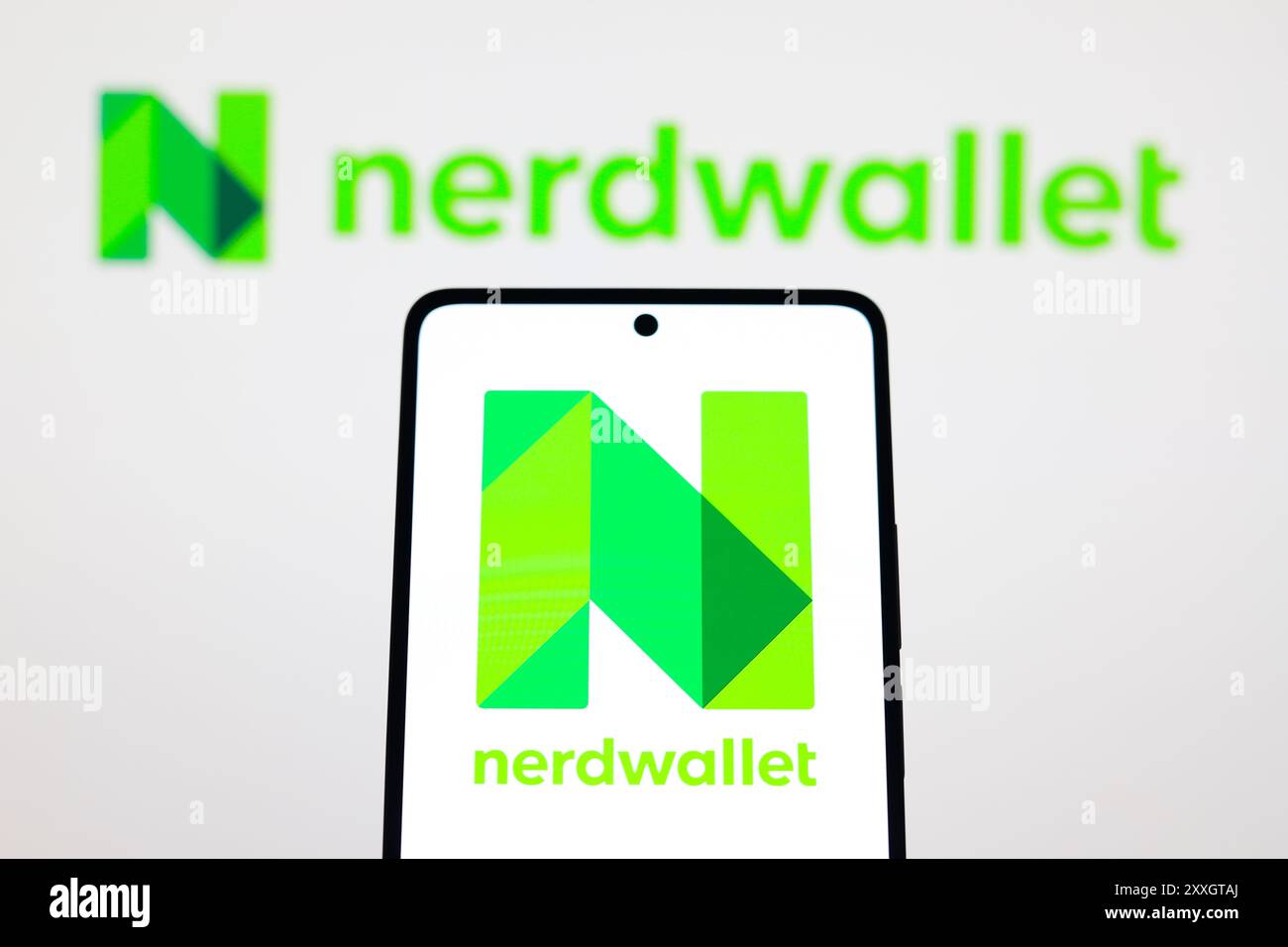 In this photo illustration, the NerdWallet logo is displayed on a ...