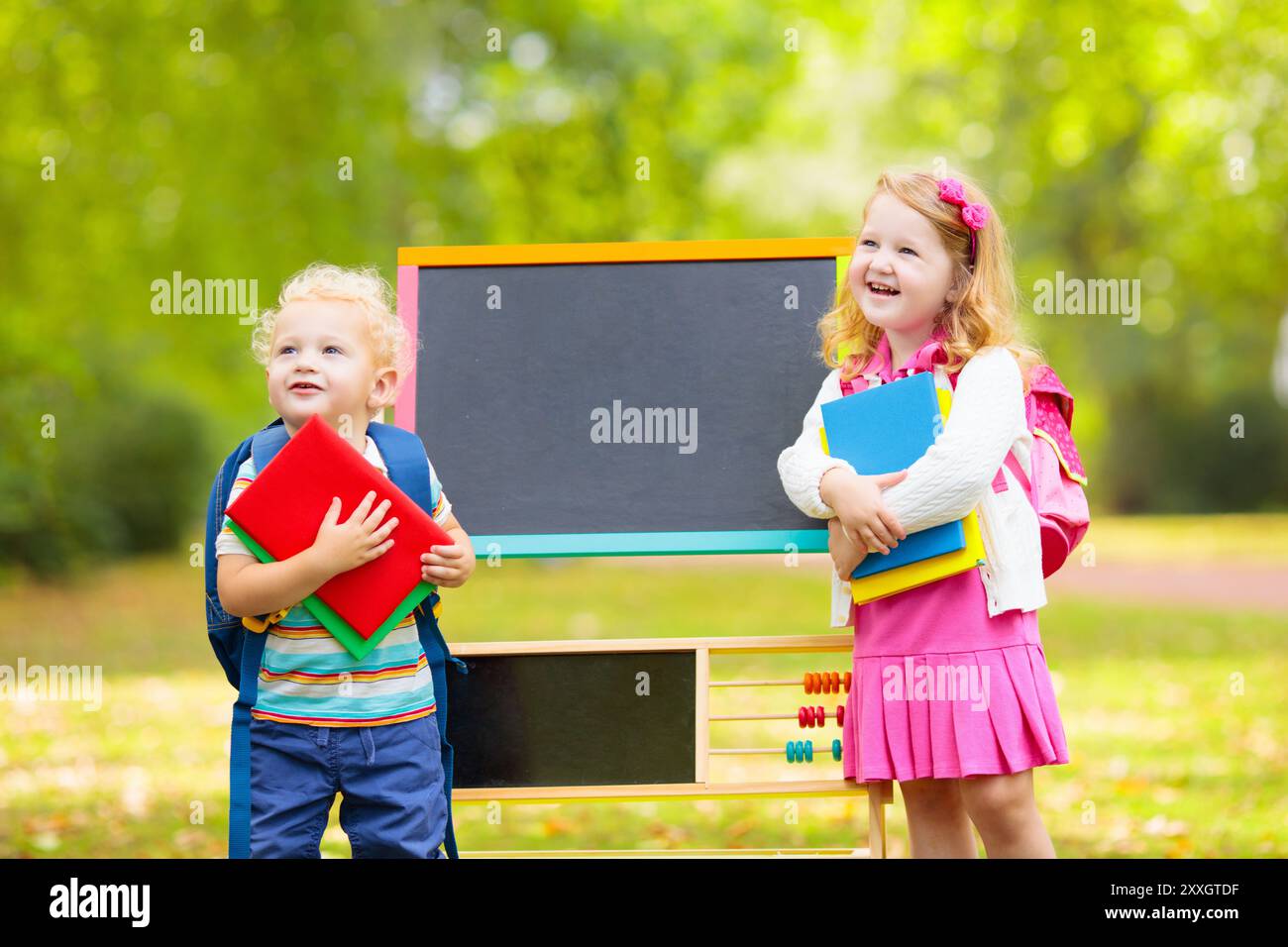 Children happy to be back to school. Preschooler girl and boy with ...