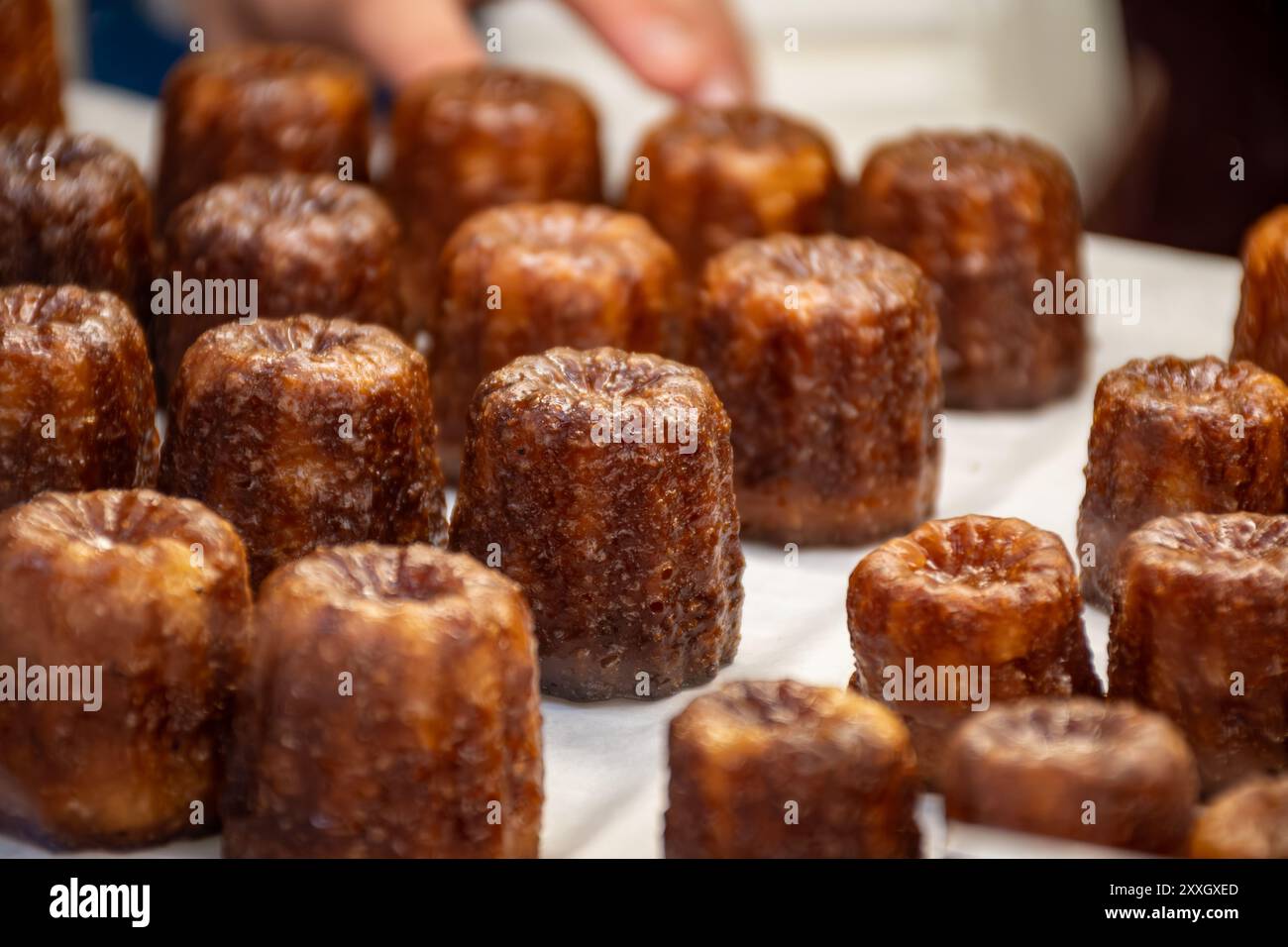 Baked Canele, French pastry flavored with rum and vanilla, specialty of ...