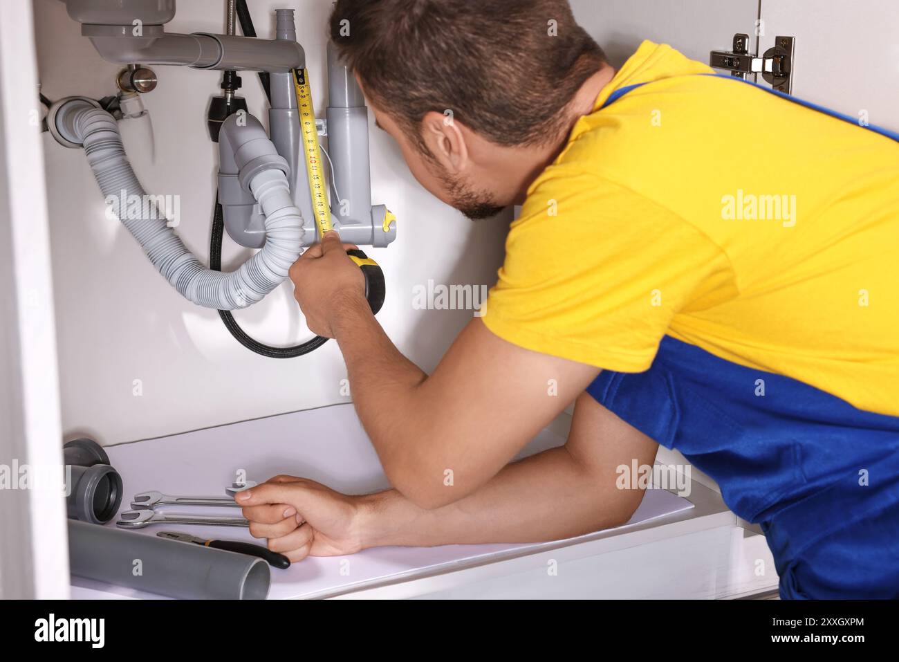 Professional plumber fixing piping system at home Stock Photo - Alamy