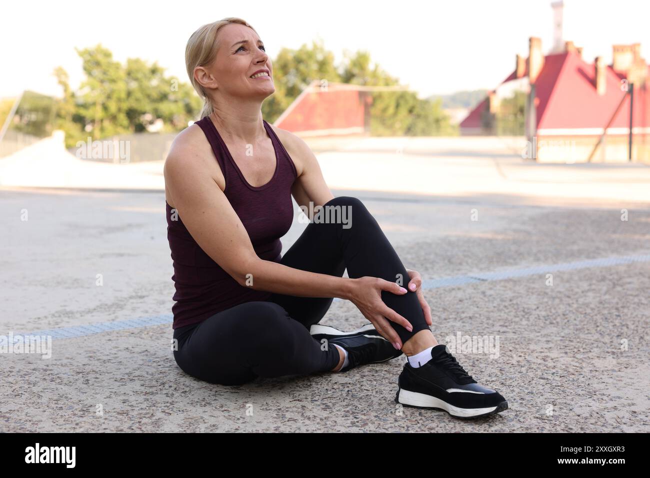 Sad woman suffering from foot pain outdoors Stock Photo - Alamy