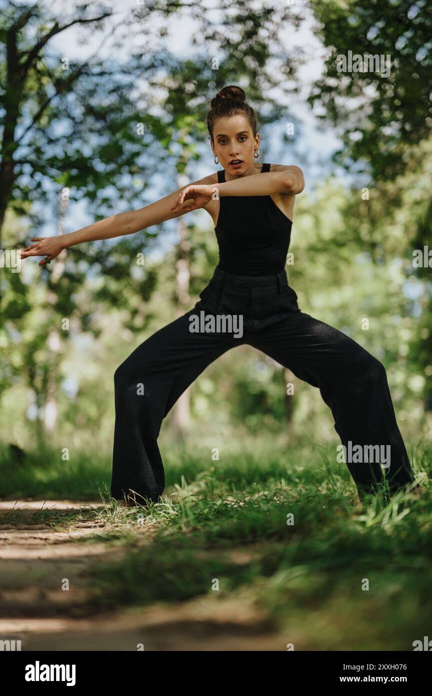 Lovely girl dancing modern style in nature, female dancer performing in a natural outdoor ...