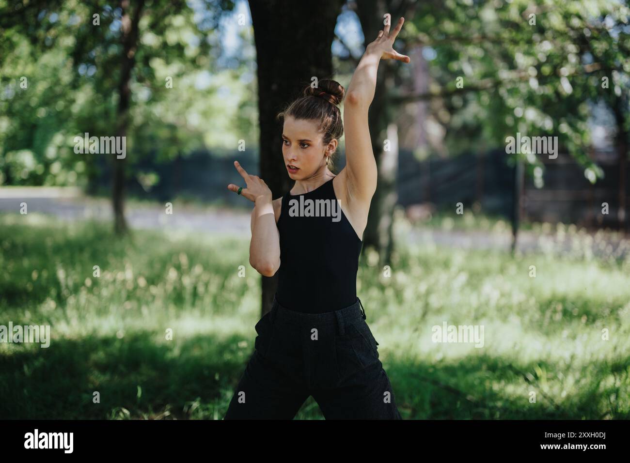 Lovely girl dancing in nature. Female dancer performing modern dance in an outdoor setting ...
