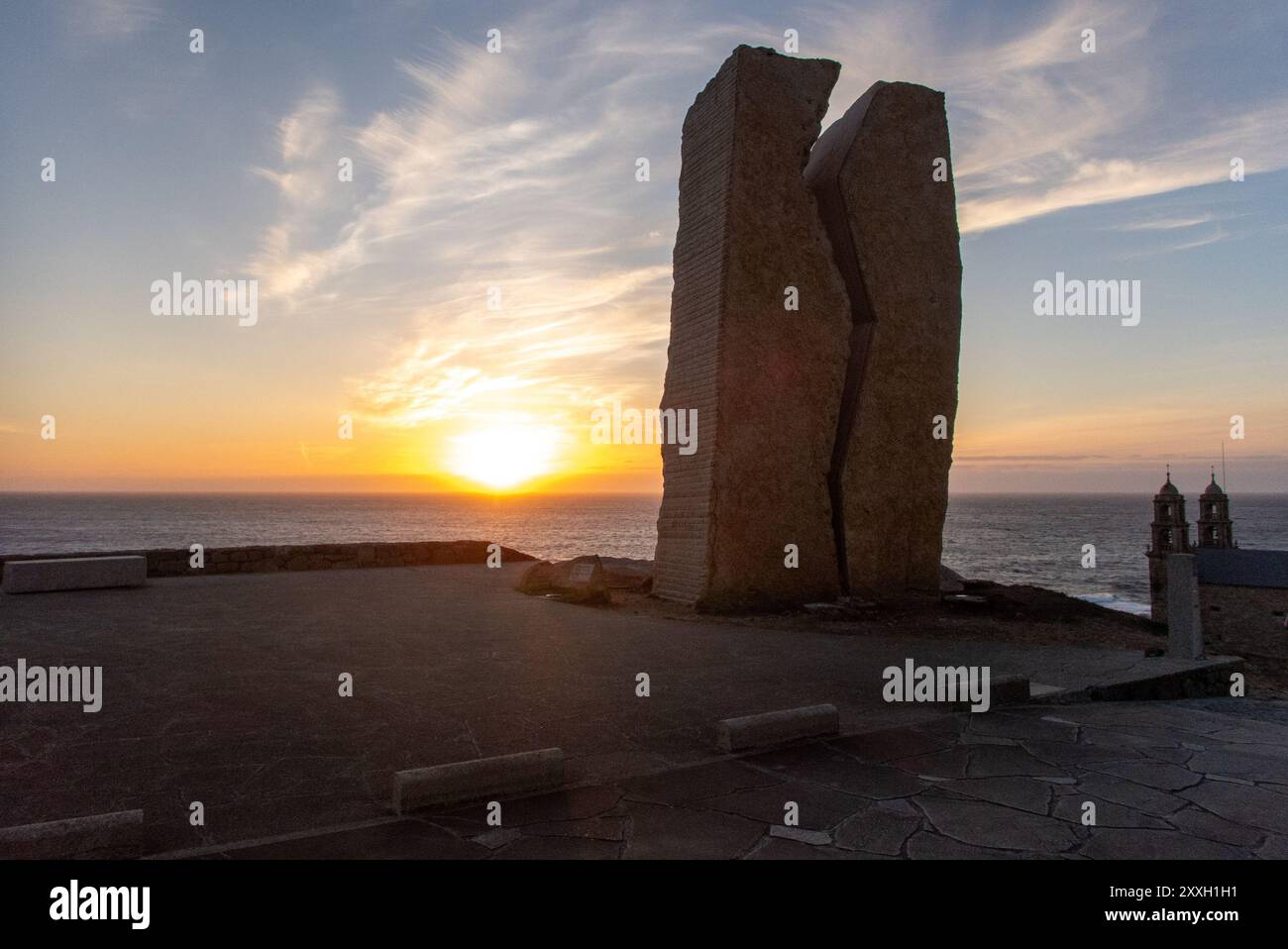 Sunset at the coast of Muxia in the Spanish Northwest. The sculpture A ...
