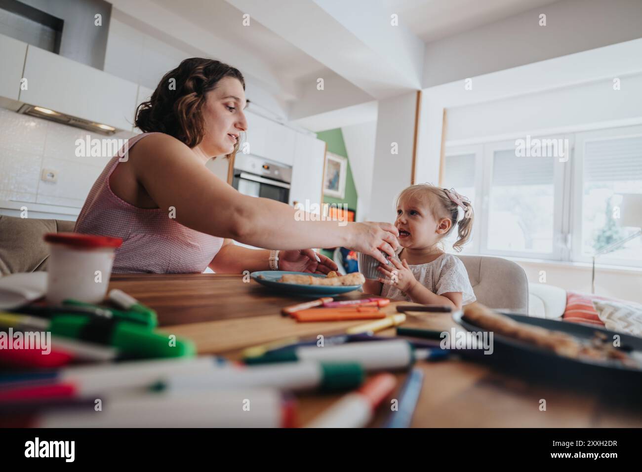 Mother and daughter enjoying art and crafts activity at home Stock ...