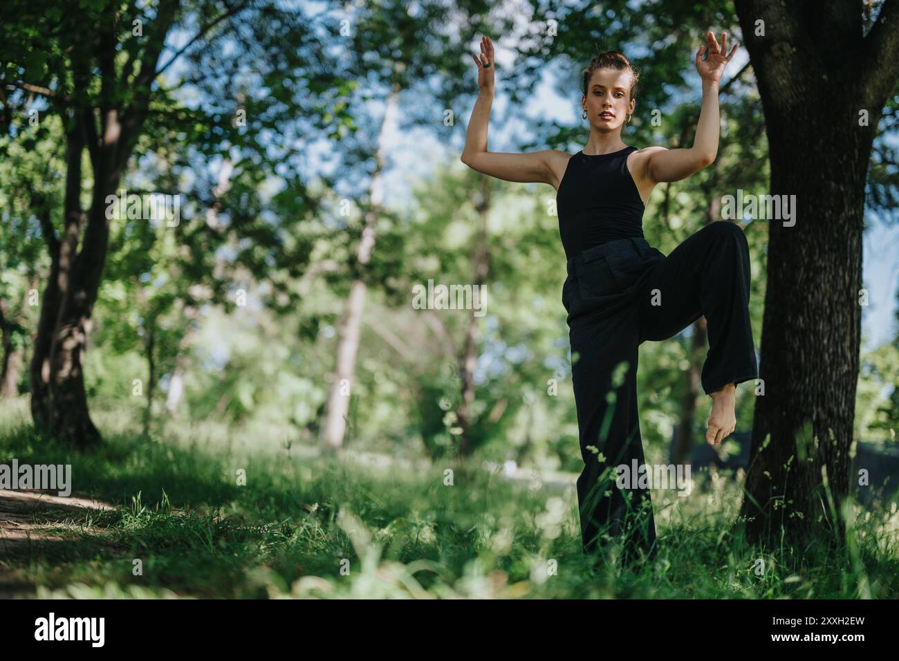 Lovely girl dancing in nature, performing modern dance in a lush green forest Stock Photo - Alamy
