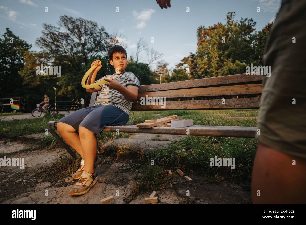Father and son enjoying building games on a park bench outdoors Stock ...