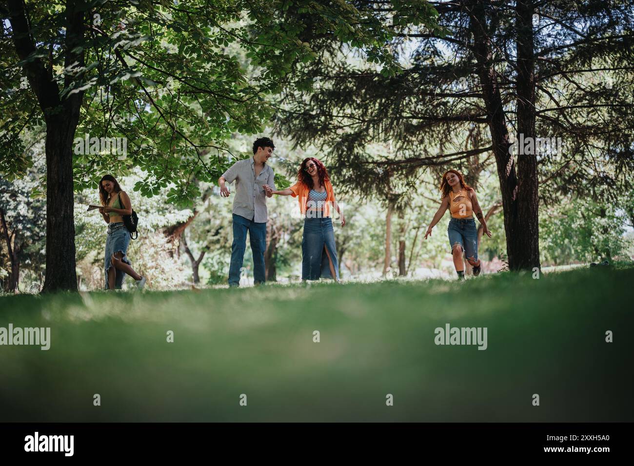 Young teenagers having fun in the park showcasing friendship, joy, and ...