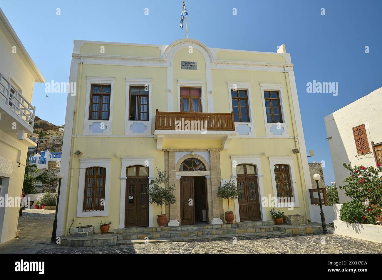 Historic building with Greek flag, well-kept entrance and windows ...