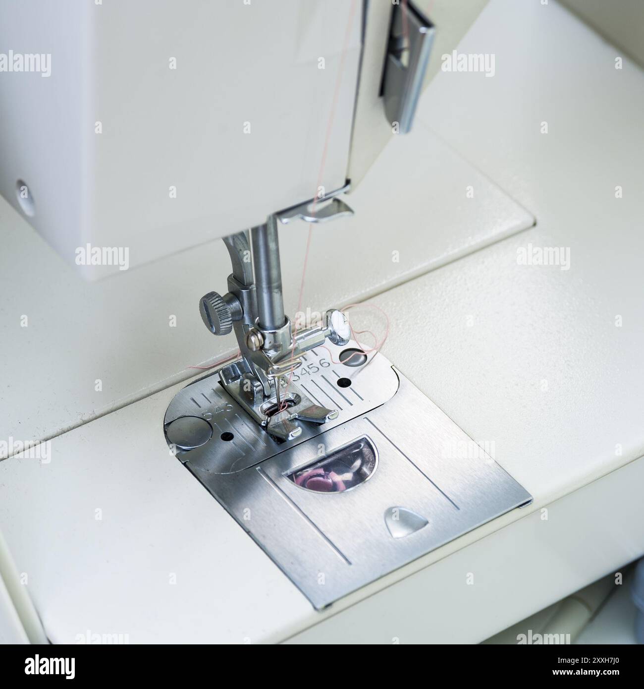 Sewing foot of an old sewing machine with needle and thread Stock Photo ...