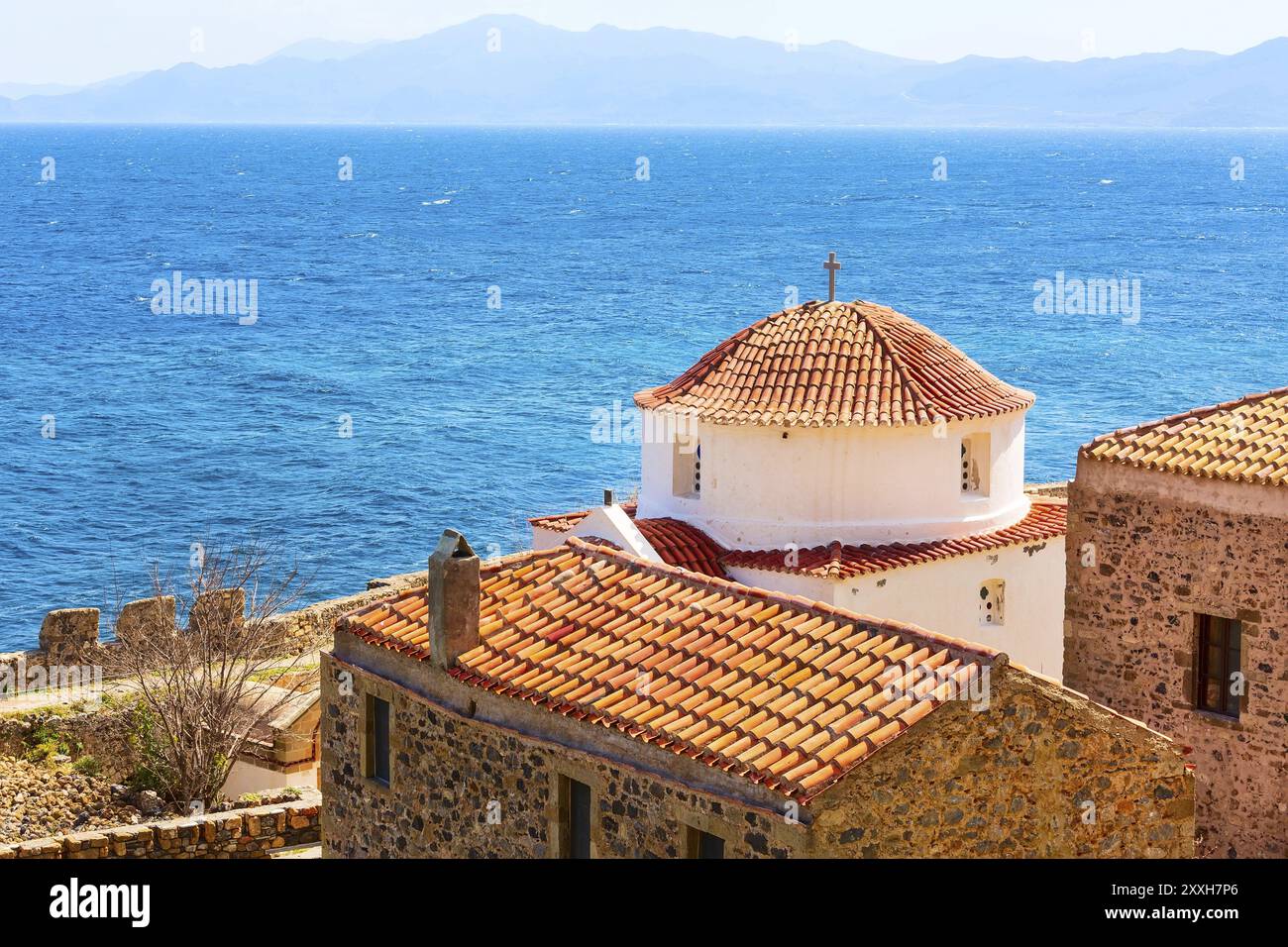 Monemvasia church, old red brick houses, roofs in ancient town and blue ...